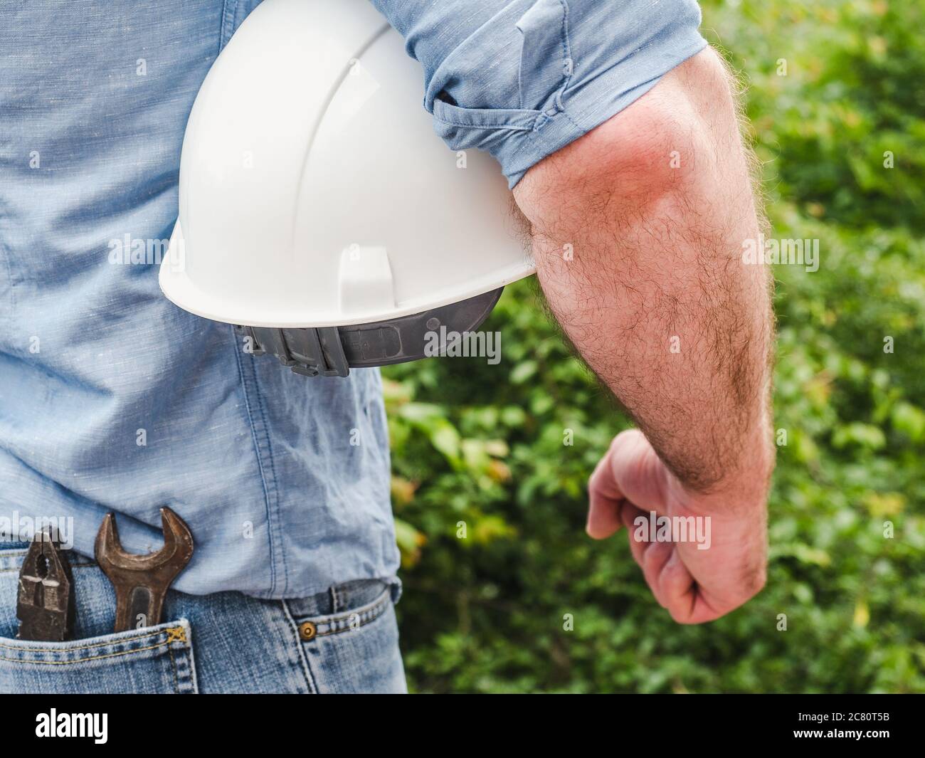 Man with tools, holding a safety helmet Stock Photo - Alamy