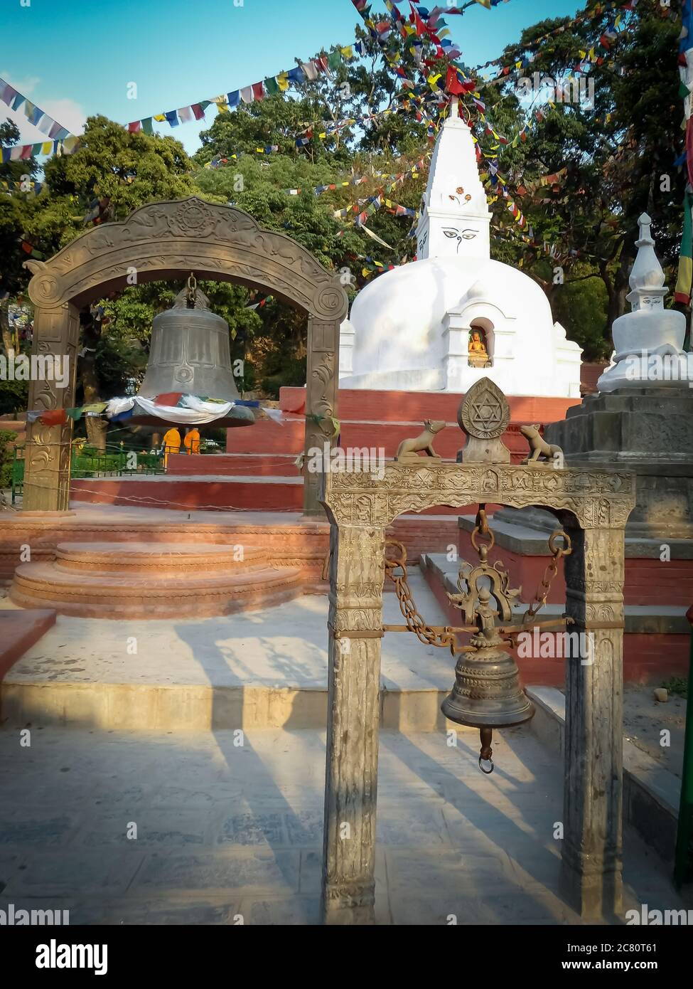 Two beautiful bells and a white stupa in Katmandu, Nepal Stock Photo ...