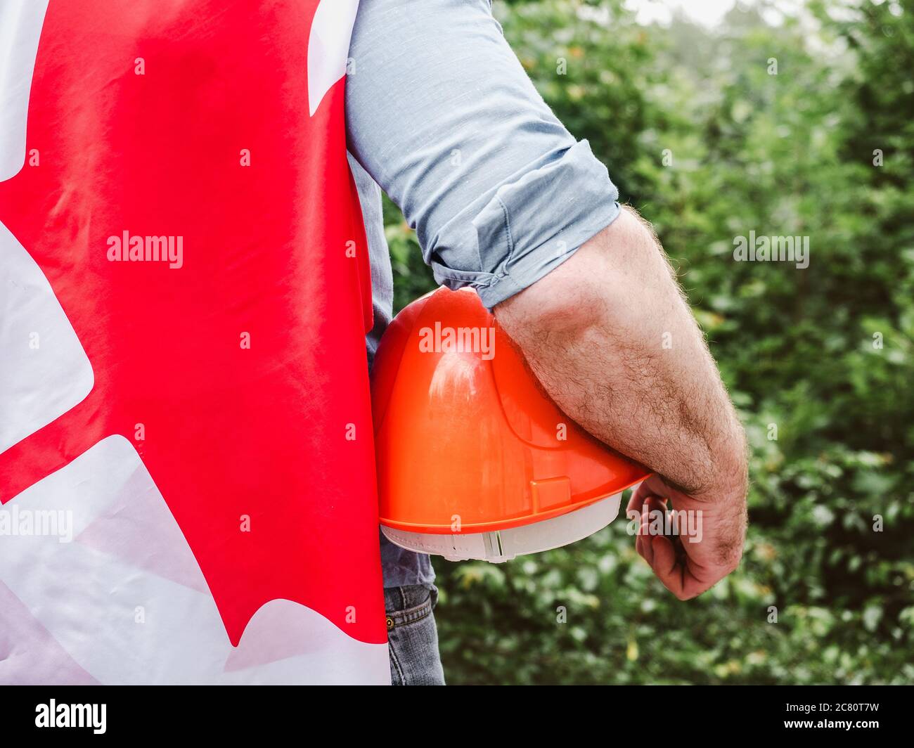 Handsome man with tools, holding a Canadian Flag Stock Photo - Alamy