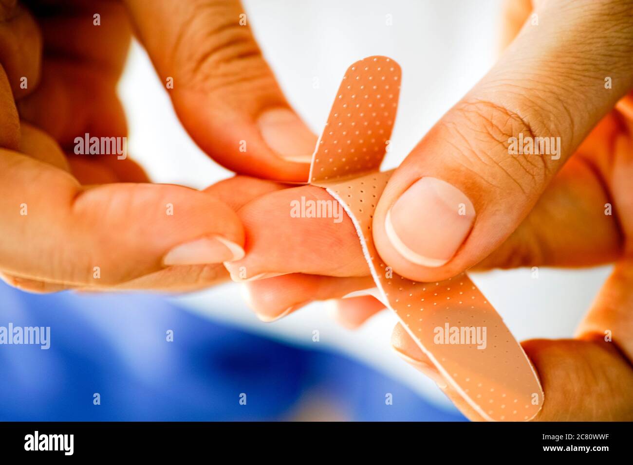 Woman applying adhesive tape hi-res stock photography and images - Alamy