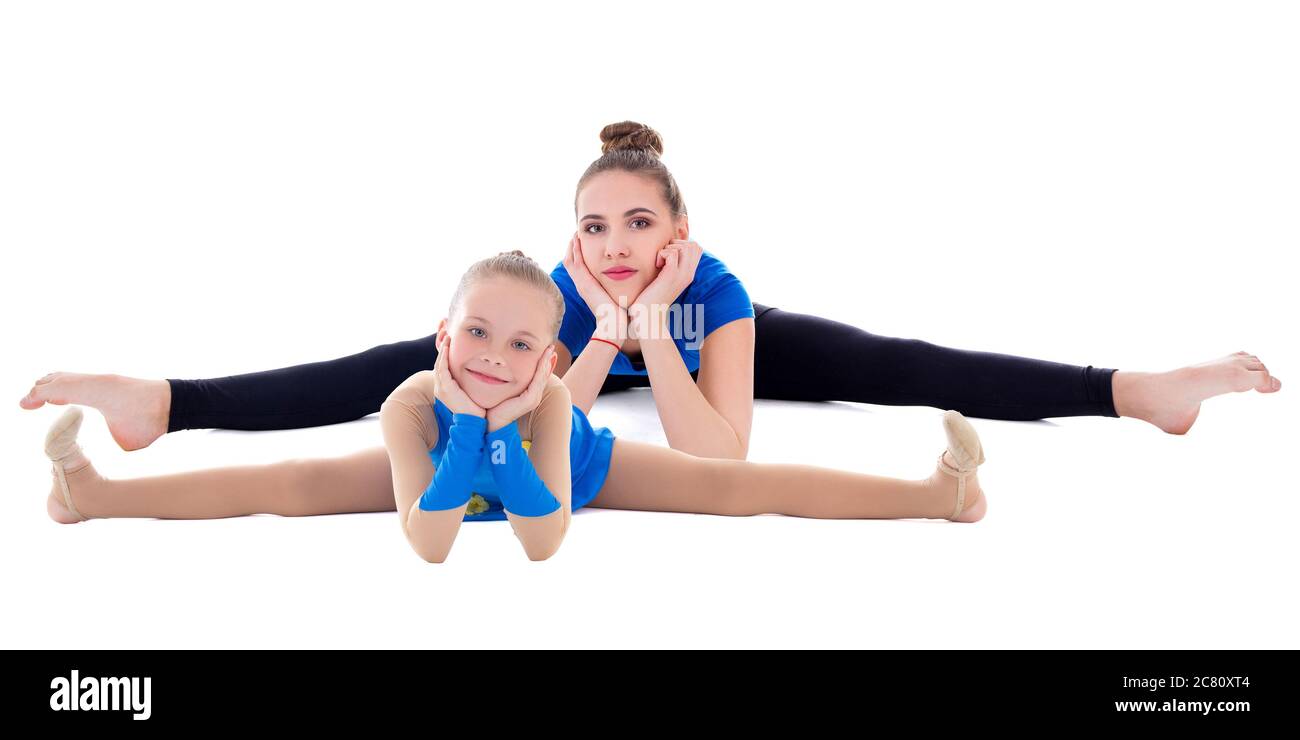 beautiful flexible woman and little girl doing stretching exercise ...