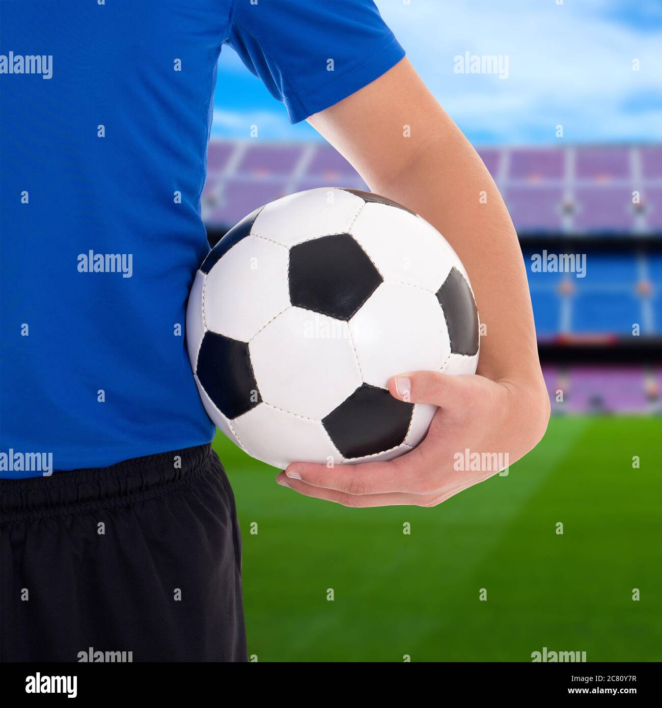 close up of soccer ball in player's hand on field of big stadium Stock ...
