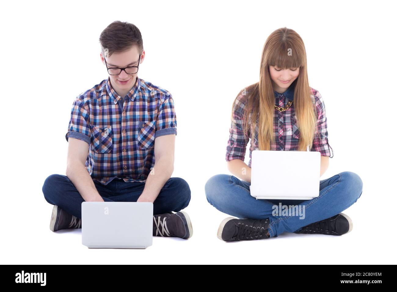teenage boy and girl sitting with computers isolated on white ...