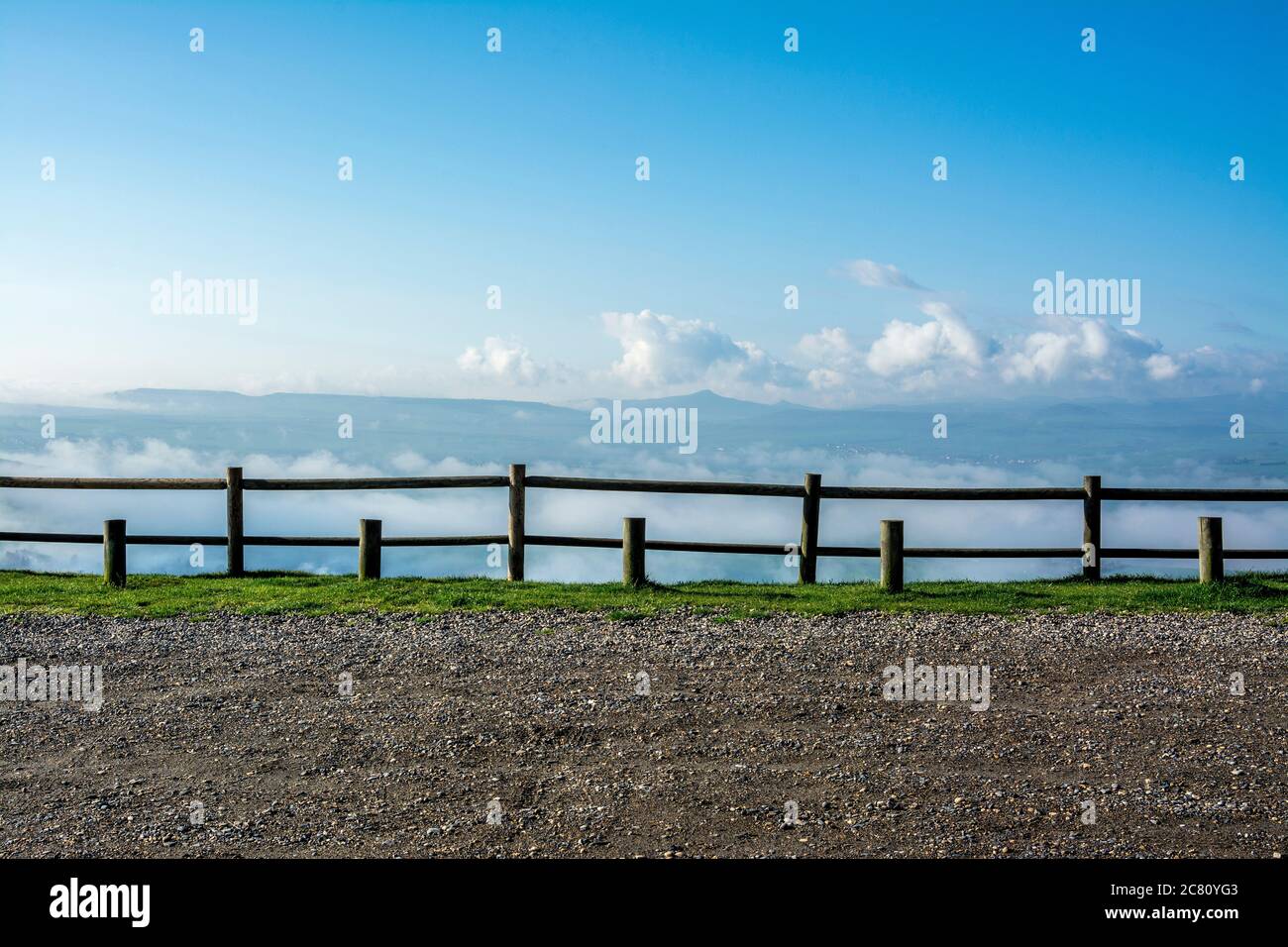 Scenic viewpoint with a wooden fence overlooking a cloud-covered ...