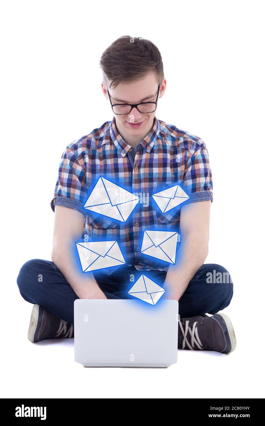 handsome teenage boy sitting with laptop and sending messages isolated ...