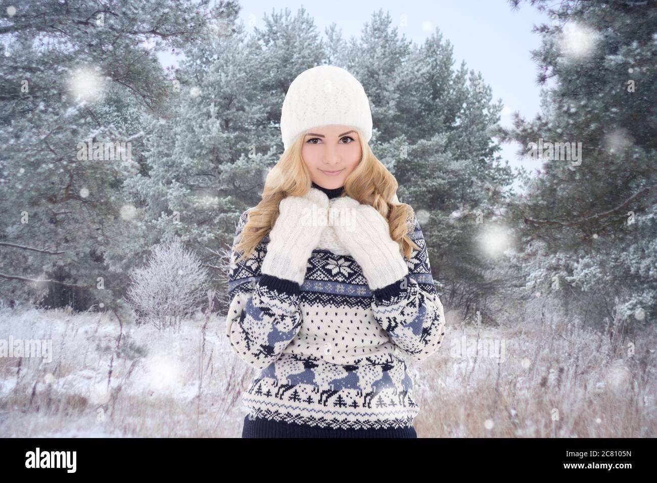pretty woman in warm clothes posing in winter forest Stock Photo - Alamy