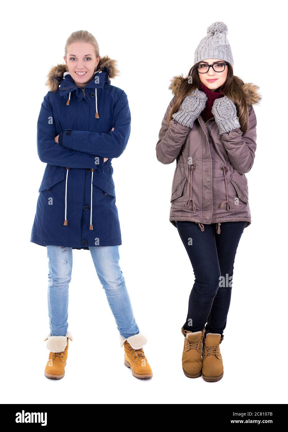 full length portrait of two young women in winter clothes isolated on ...