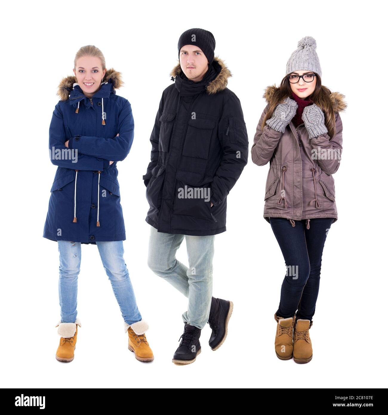 full length portrait of young man and two women in winter clothes ...