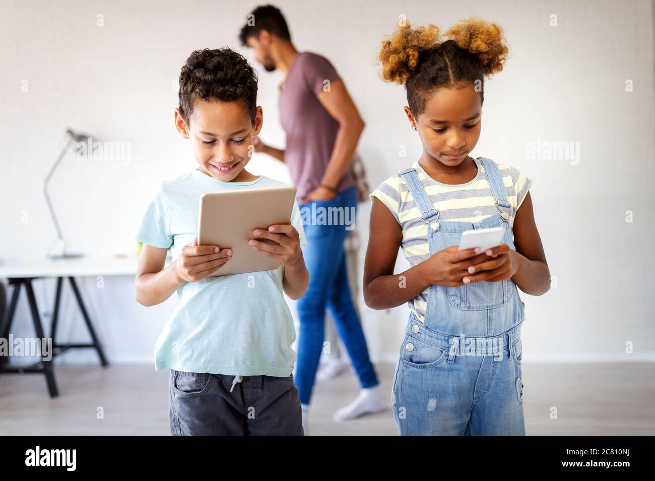 Happy children havig fun and using technology devices Stock Photo - Alamy