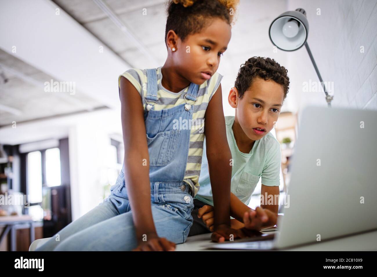 Kids, technology concept. Happy children using laptop to learn, play ...
