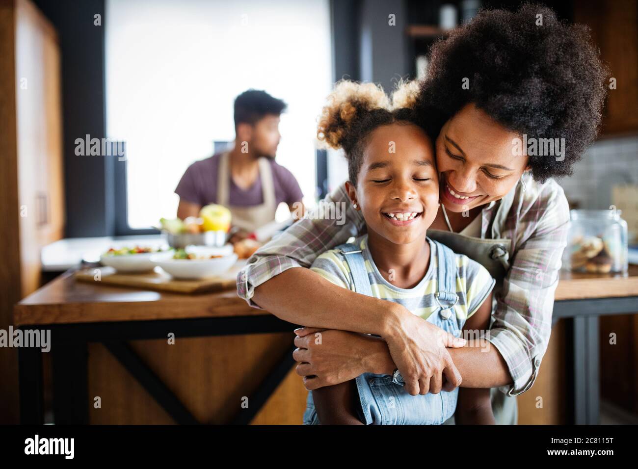 Happy family in the kitchen having fun and cooking together. Healthy ...