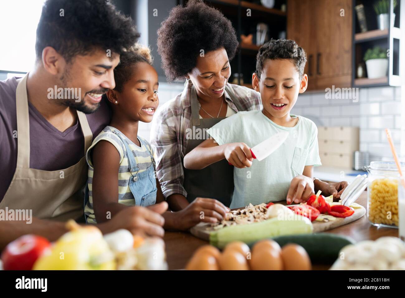 Happy family in the kitchen having fun and cooking together. Healthy ...