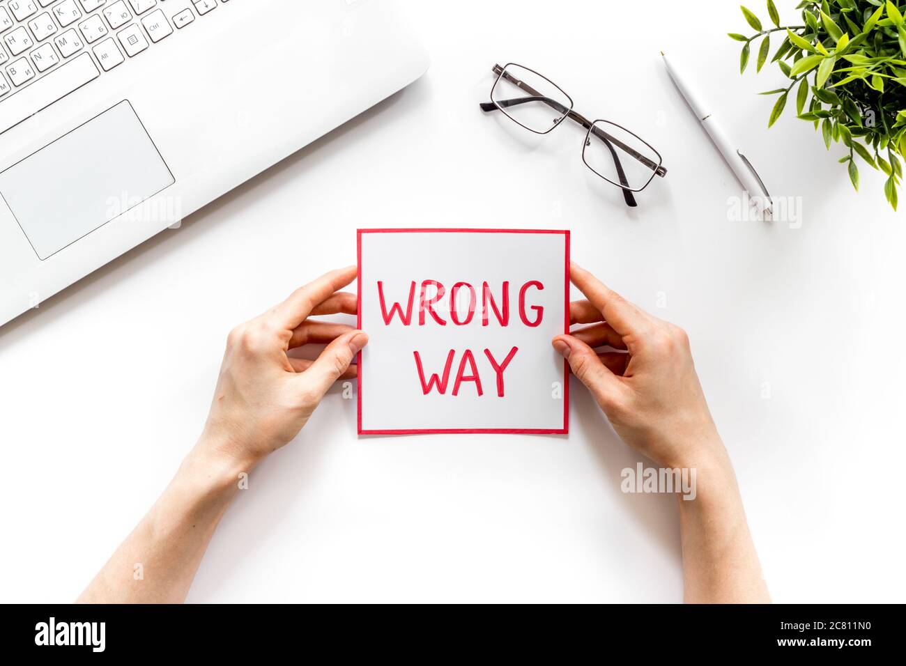 Business failure. Wrong way icon in hands on office desk top-down Stock ...