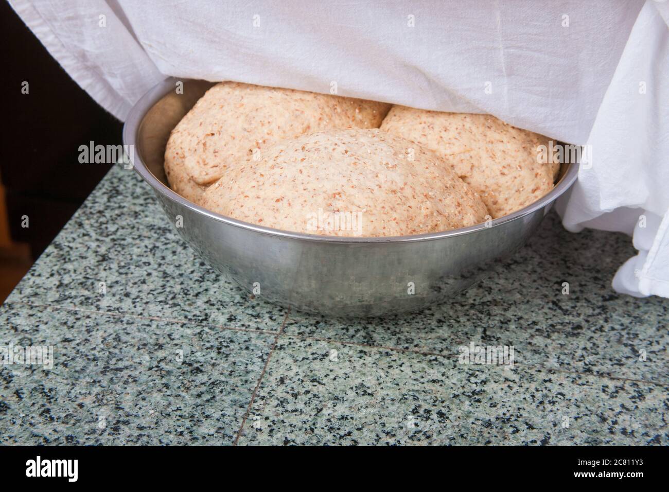 Three balls of multigrain bread dough that have risen sufficiently ...