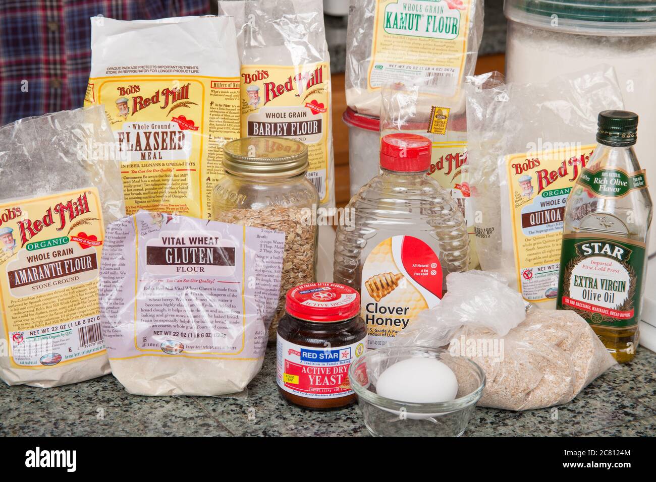 Breadmaking ingredients (various flours, honey, oats, yeast, egg, olive ...