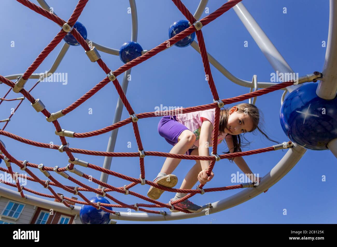 Teenage girl is playing at the playpen Stock Photo - Alamy