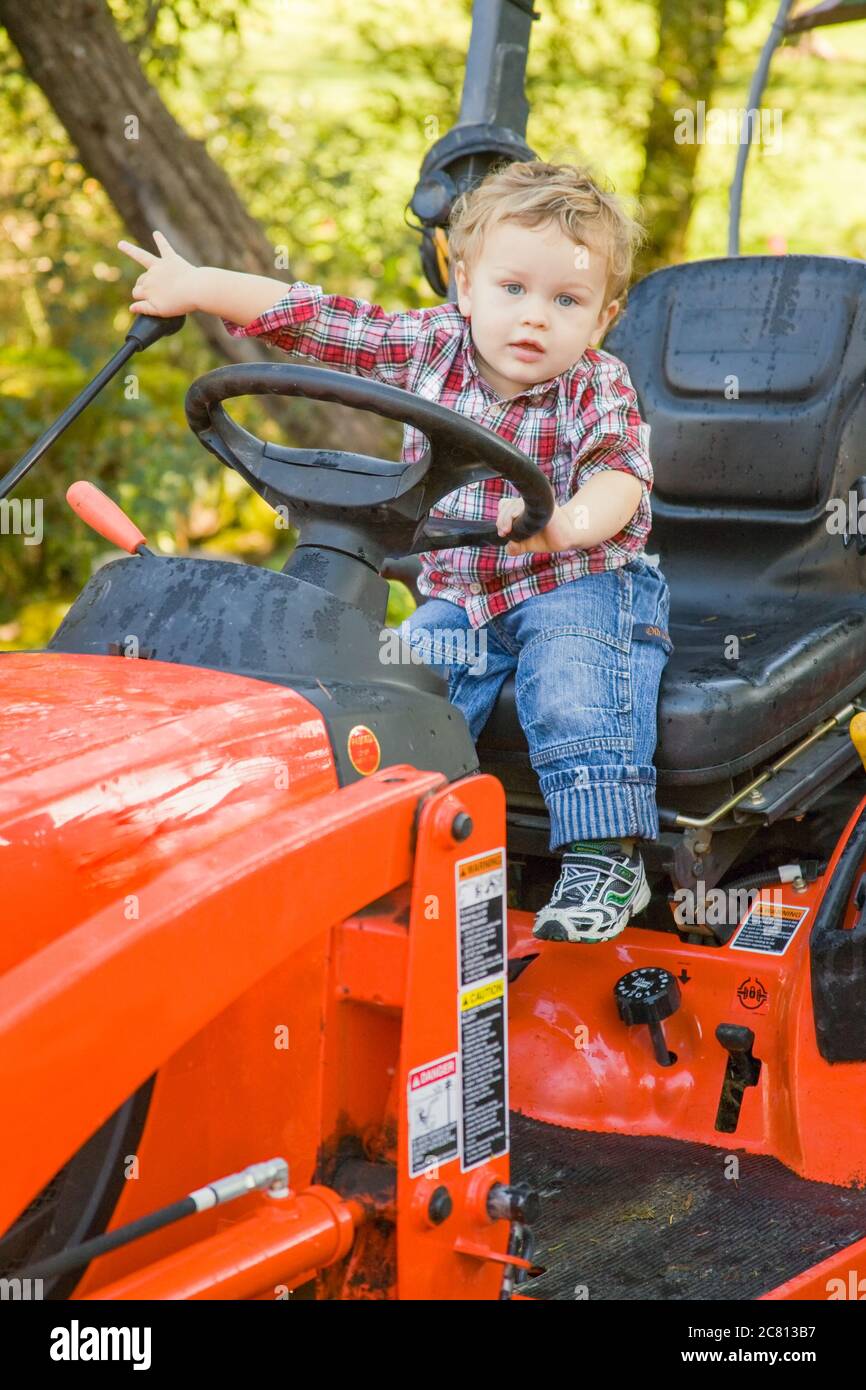 Toddler boy sitting on a tractor pretending to drive it in Fall City ...