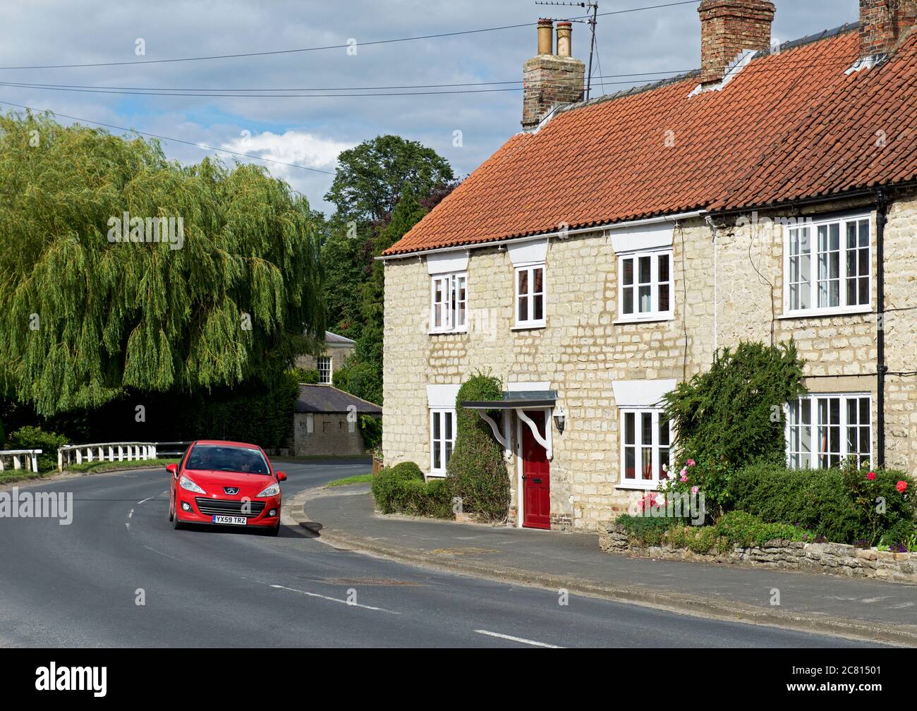 The B1257 road through the estate village of Hovingham, Ryedale, North ...