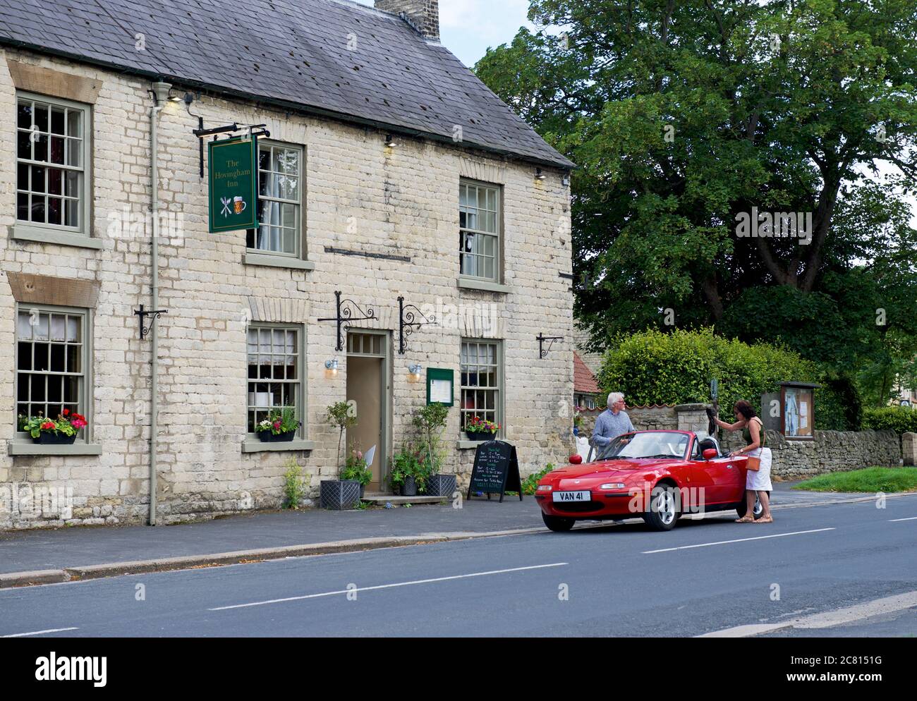 Red Mazda MX5 sports car parked outside the Hovingham Inn, in the ...