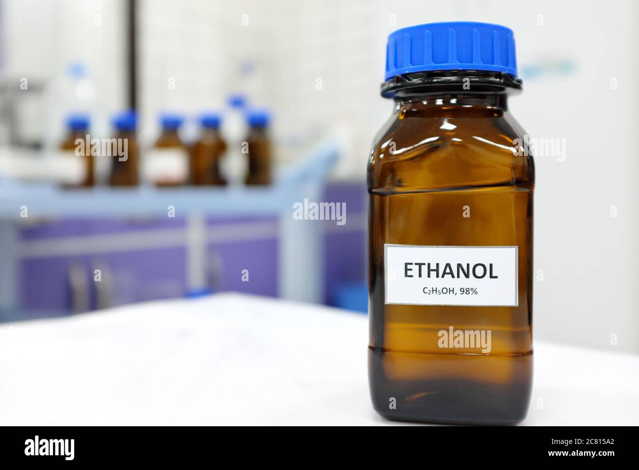 Selective focus of ethanol or ethyl alcohol brown amber glass bottle ...