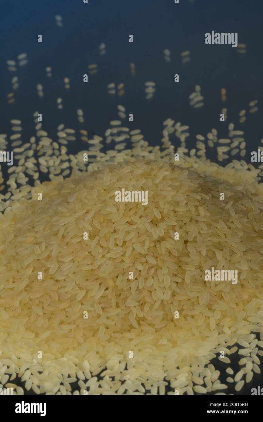 Raw rice as background. Mirror. Studio photography Stock Photo - Alamy