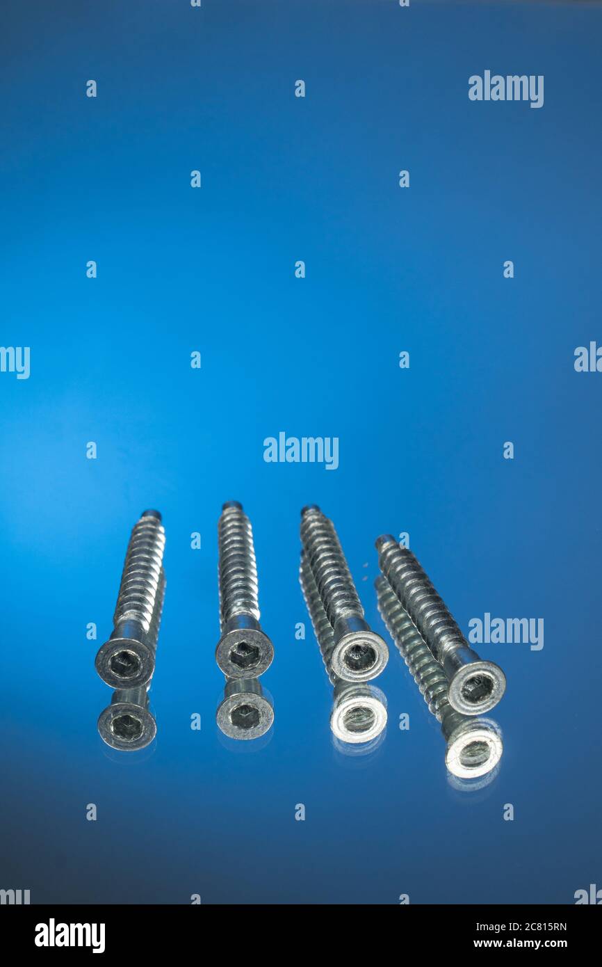 Countersunk wood screws on a blue background Stock Photo - Alamy