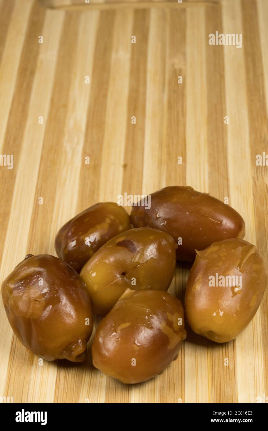 Dates fruit. Pile of fresh dried date fruits in a basket Stock Photo ...