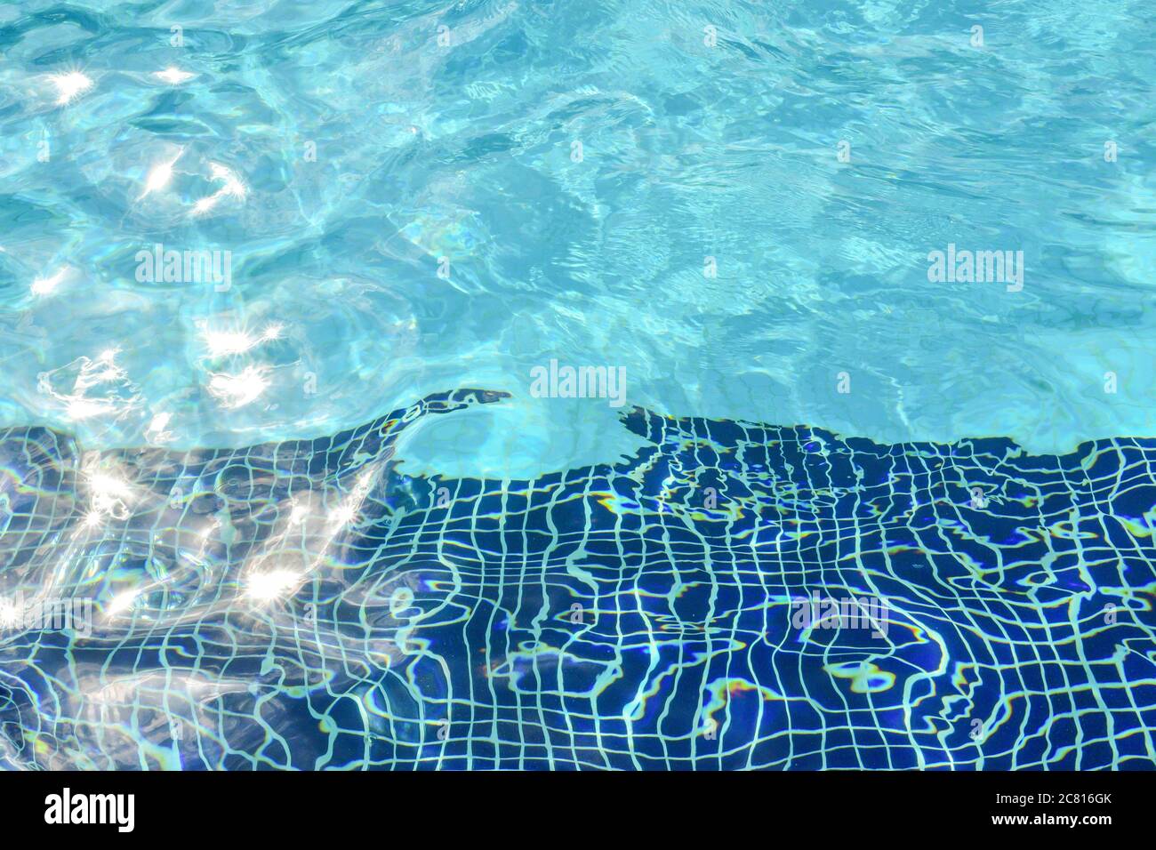 Blue pool water with sun reflections. Blue water ripple background ...