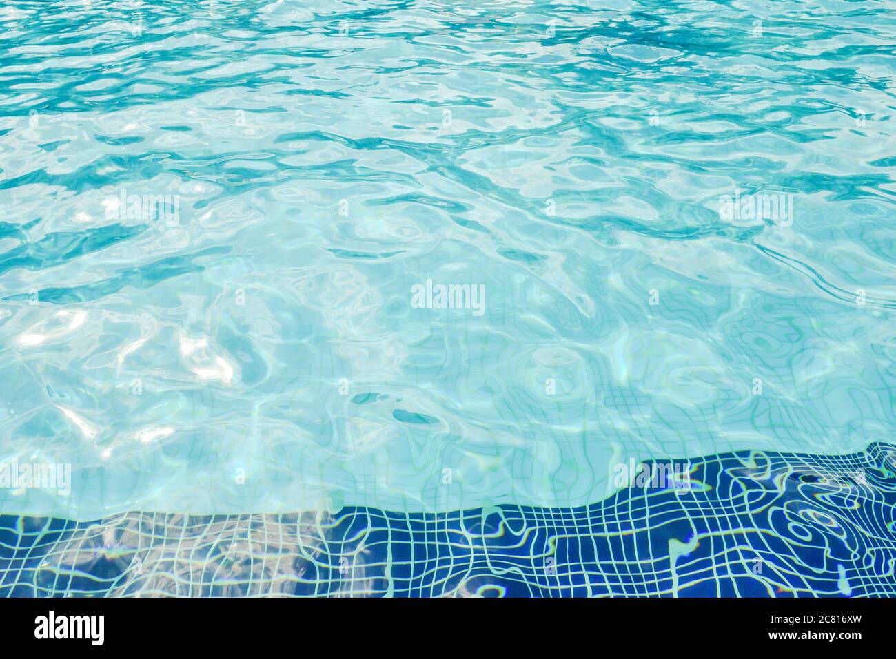Blue pool water with sun reflections. Blue water ripple background ...