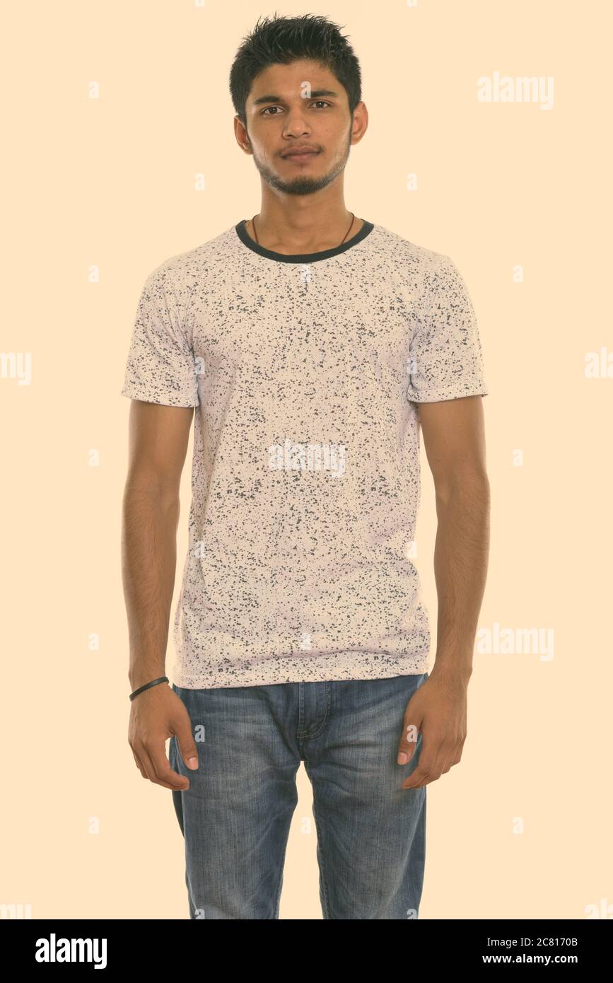Studio shot of young handsome Indian man standing Stock Photo - Alamy