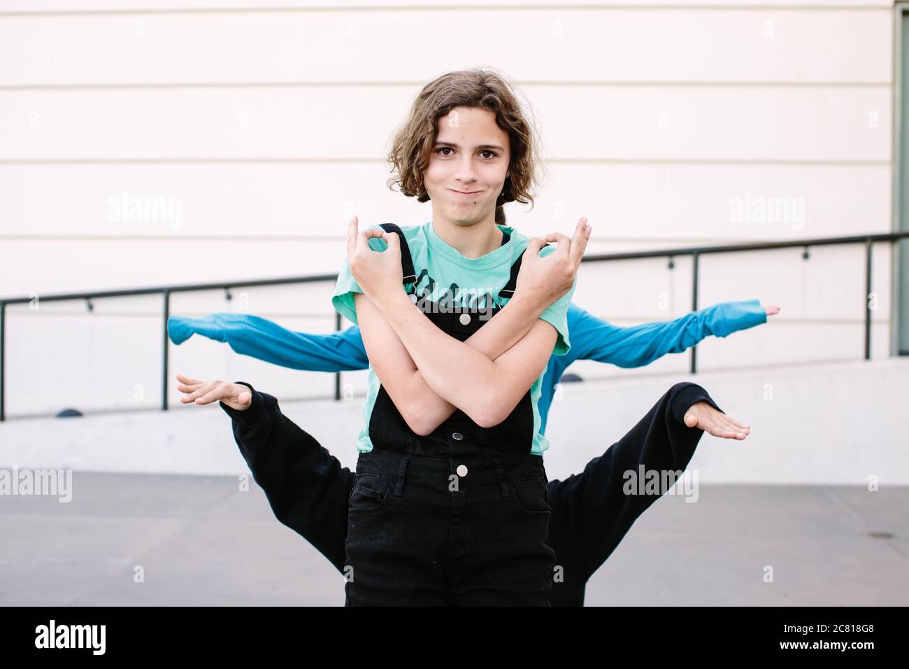 Teen girl poses with siblings to appear that she has six arms Stock ...