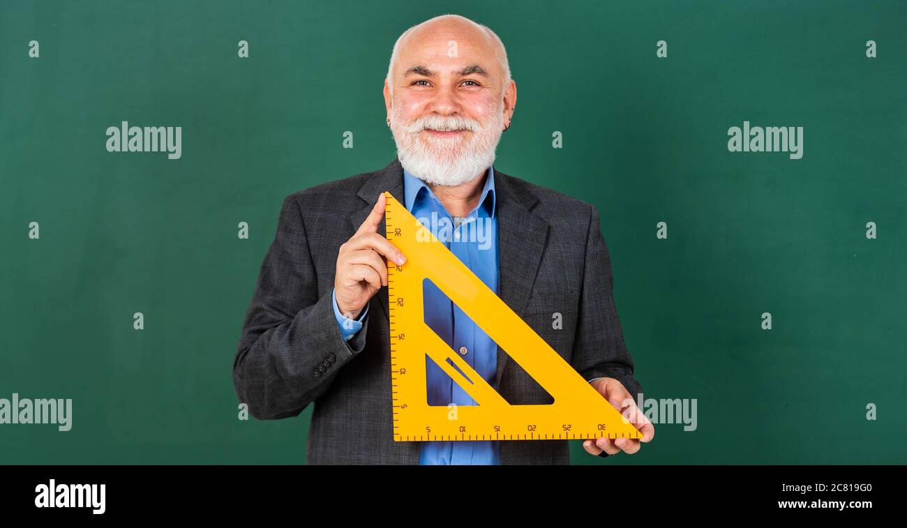 senior man teacher use math triangle tool. bearded tutor man at ...