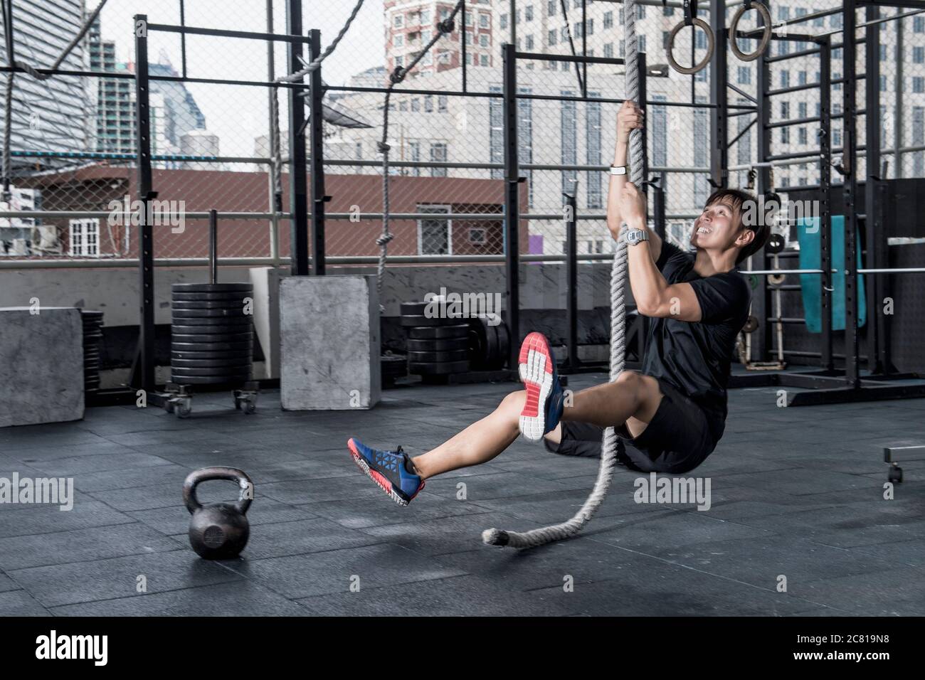 man training with ropes at rooftop gym in Bangkok Stock Photo - Alamy