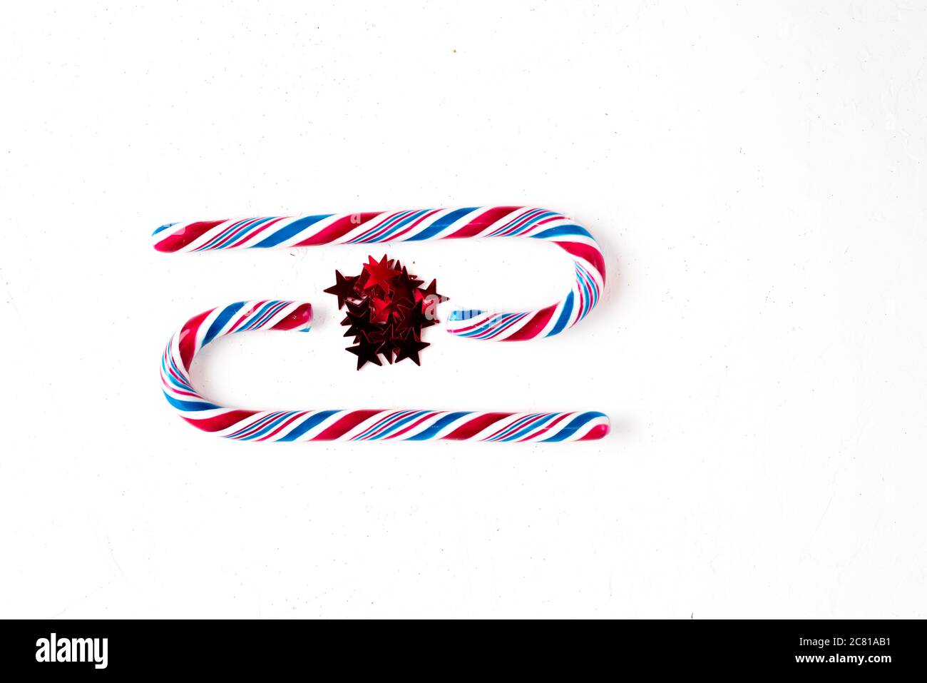 Candy canes on a white surface, top view Stock Photo - Alamy