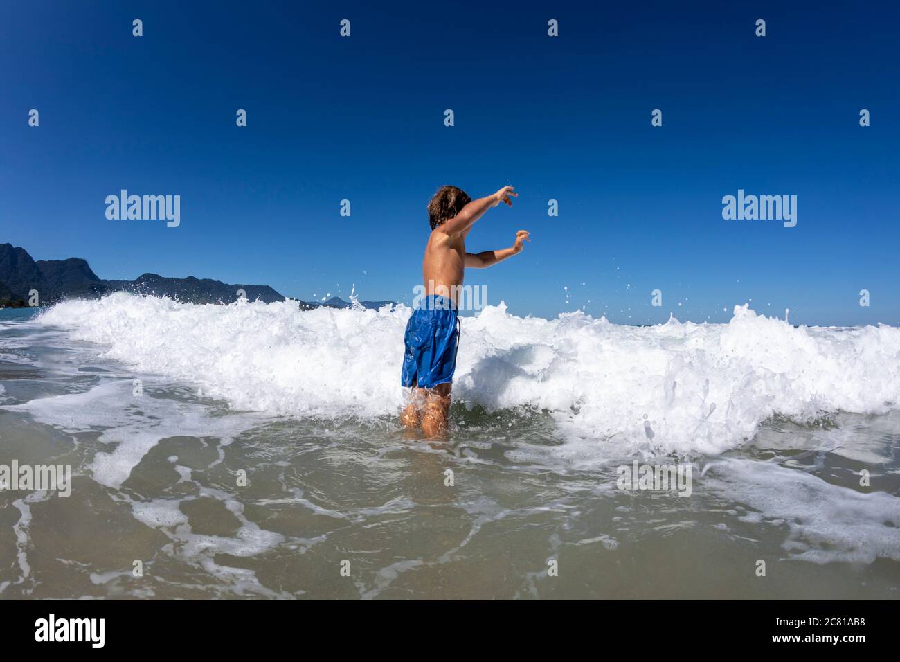 Child jumping over waves hi-res stock photography and images - Alamy