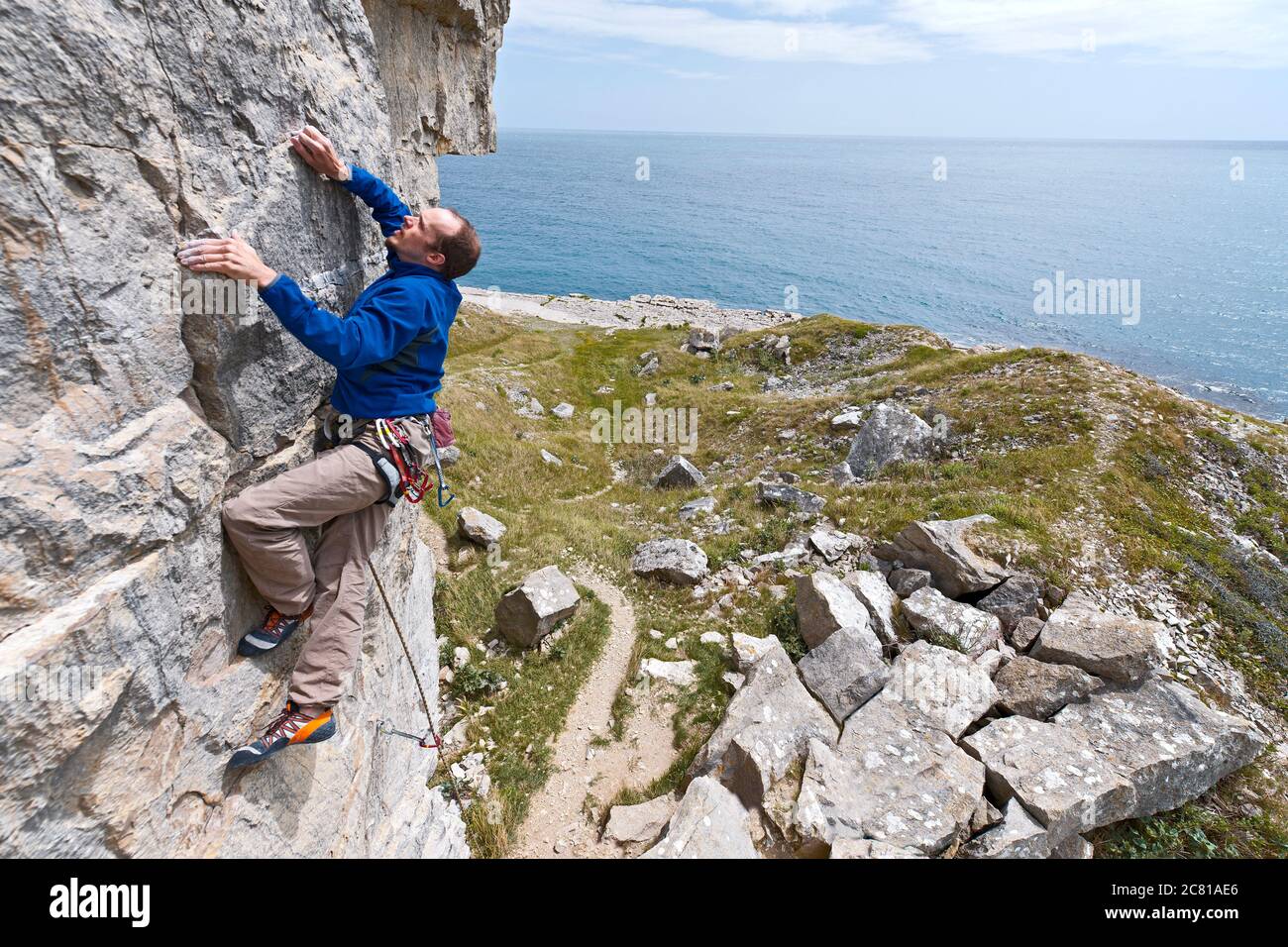 man climbing on limestone cliff near the coast of Swanage / UK Stock ...