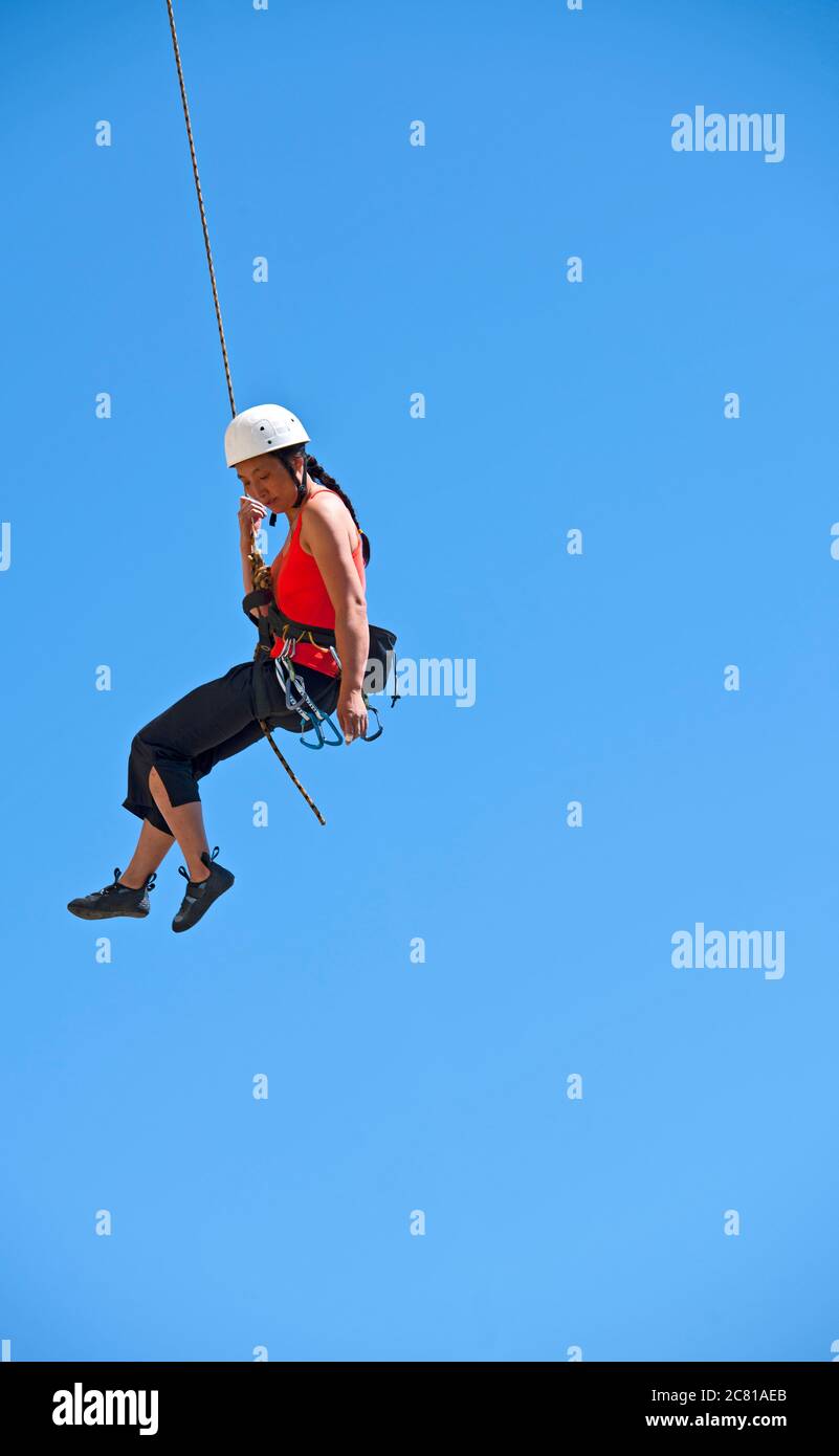 woman rappelling from rock face in Swanage / UK Stock Photo - Alamy