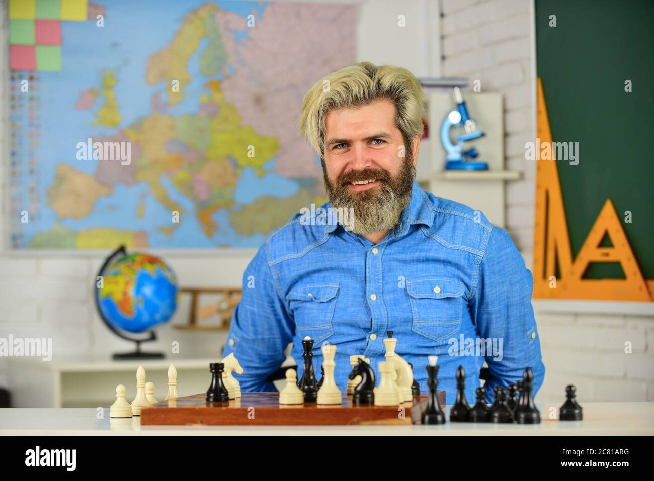 playing chess develops brain functioning. man hold chess piece ...