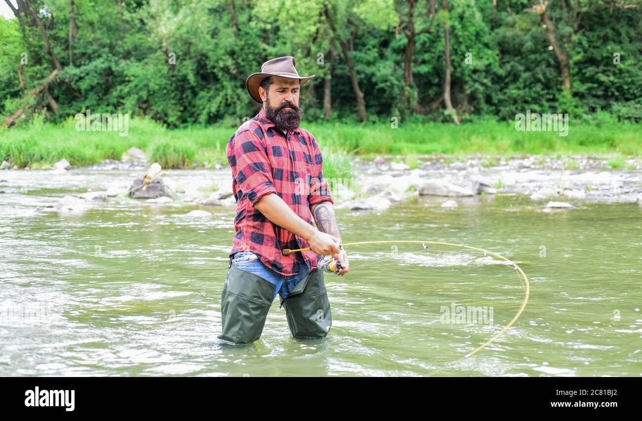 Time To Enjoy. mature man fly fishing. man catching fish. hobby and ...