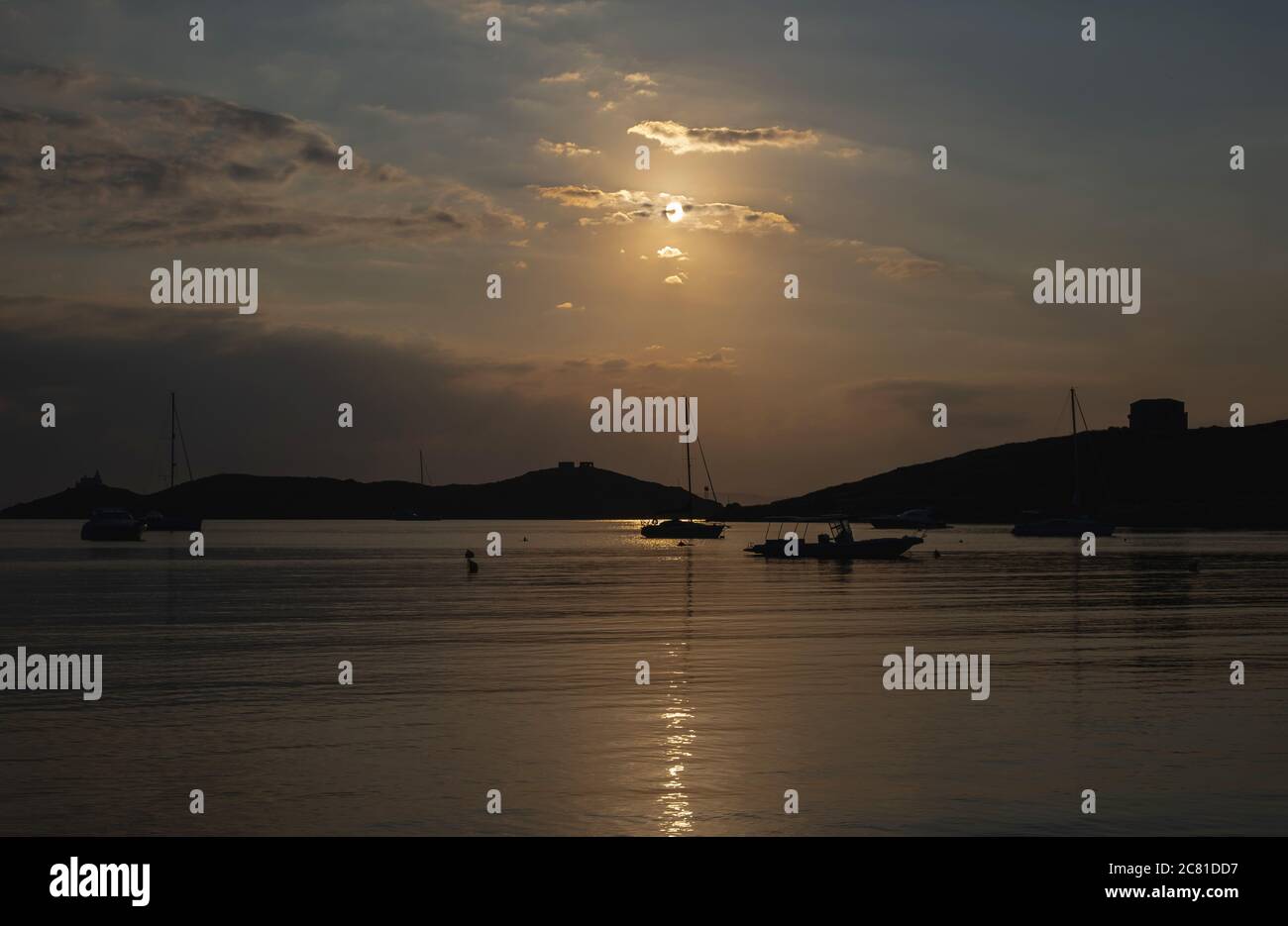 Kea island, Greece. Sunset over sea water. Boats anchored at Vourkari ...