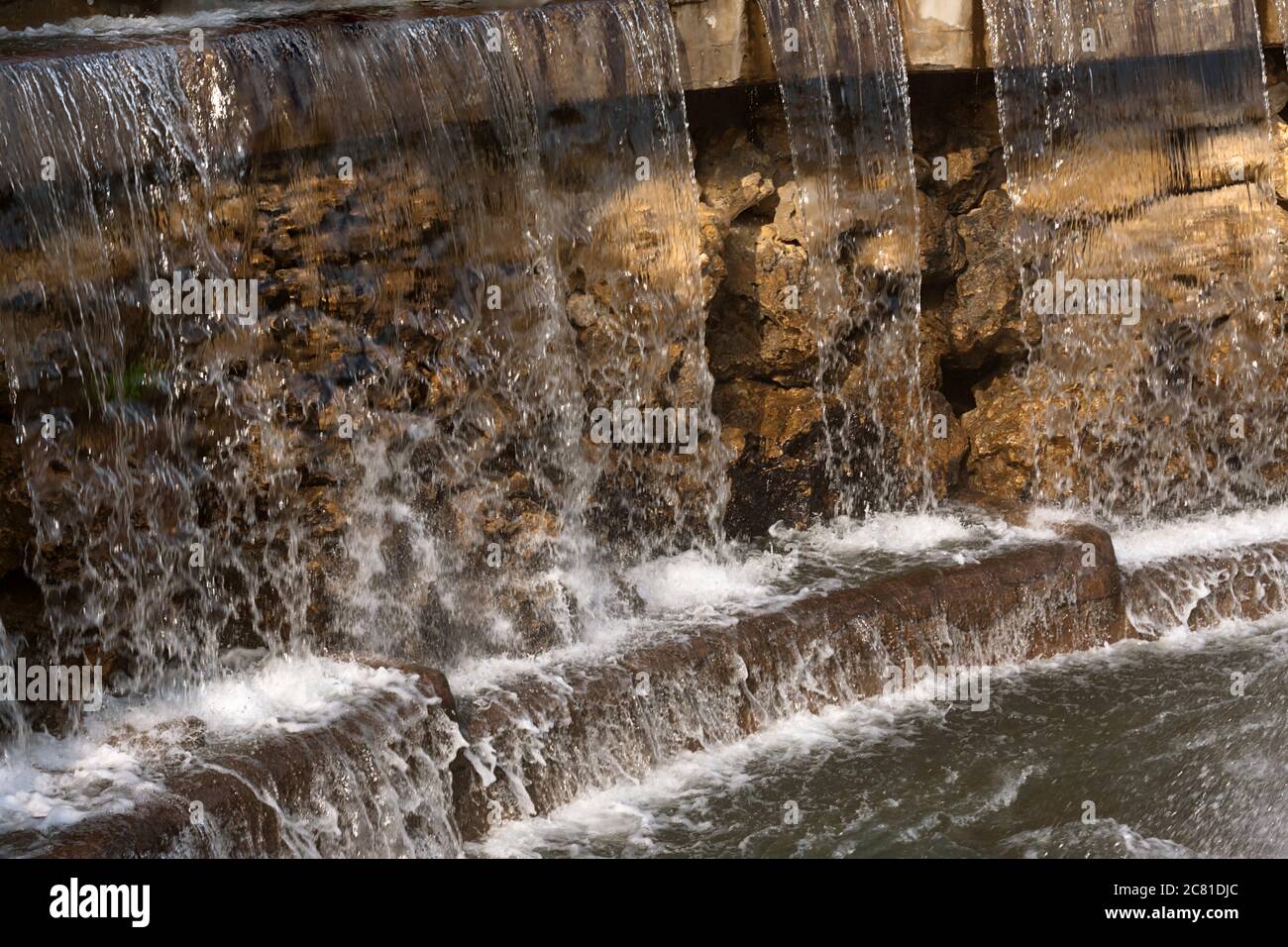The water falling from above on stones on a decline of day Stock Photo ...