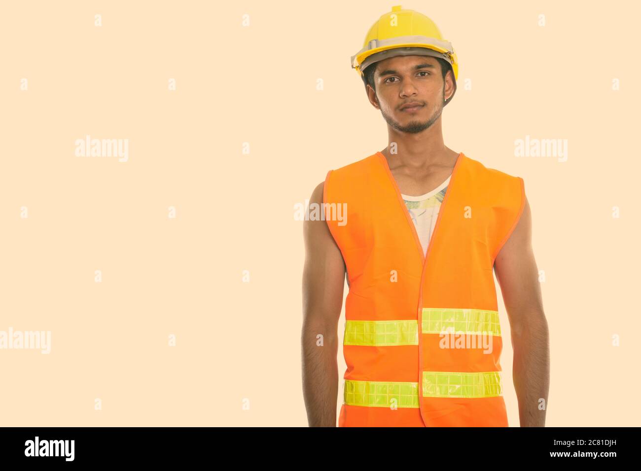 Studio shot of young handsome Indian man construction worker Stock ...