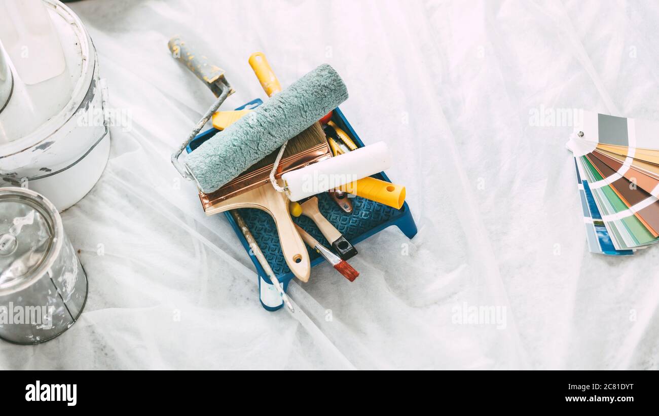 paint, construction tools and color palette on the floor in the ...
