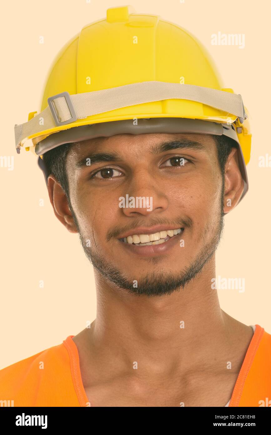 Face of young happy Indian man construction worker smiling Stock Photo ...