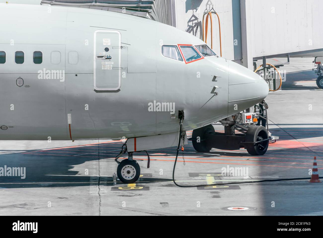 Passenger aircraft connected to ground power, waiting parked at the ...