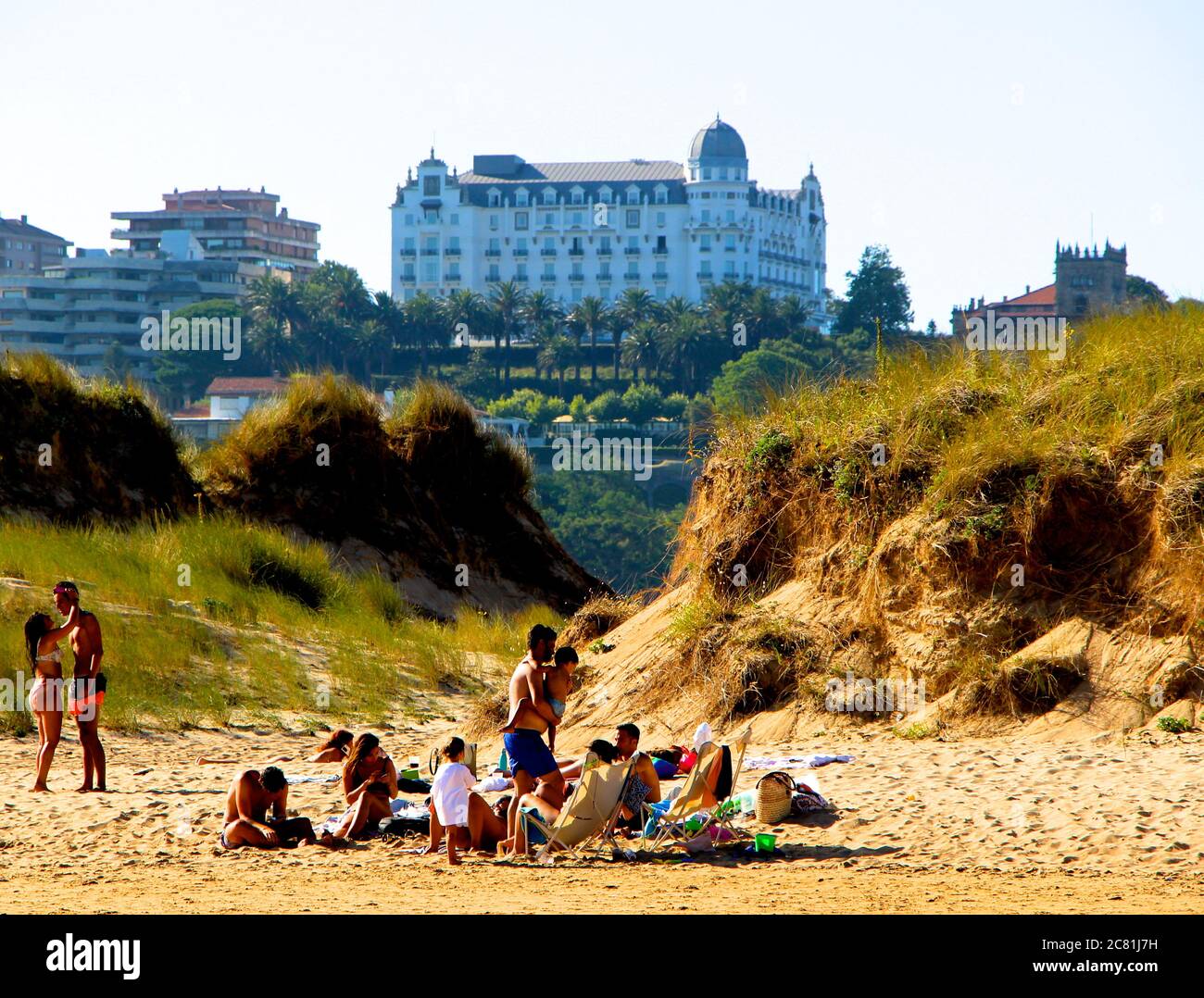 Family sun bathing on the beach with the Hotel Real in the distance ...