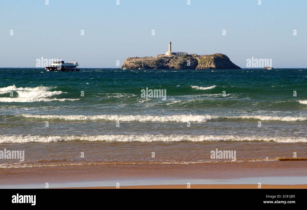Pleasure boat seen from the beach of Somo with the Isla de Mouro Moors ...