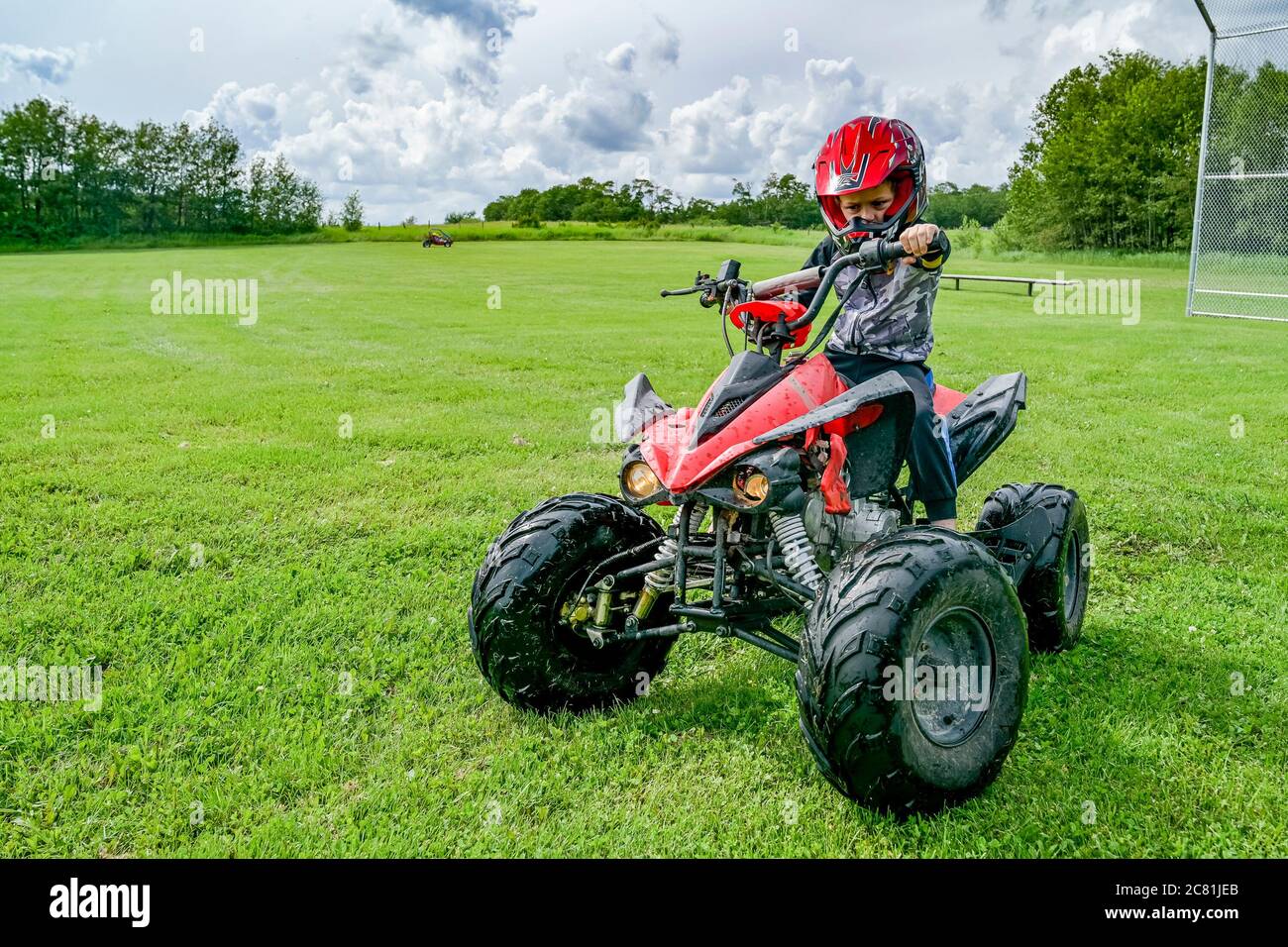 Young boy on quad, ATV, recreational off road vehicleAlberta, Canada ...