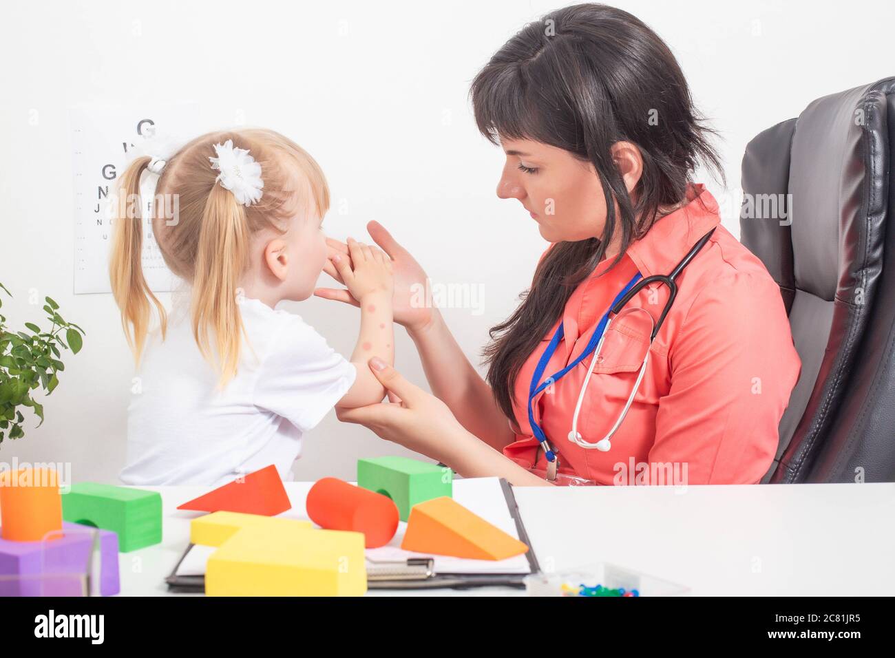 An allergist doctor examines a child s hand with redness and a rash on ...