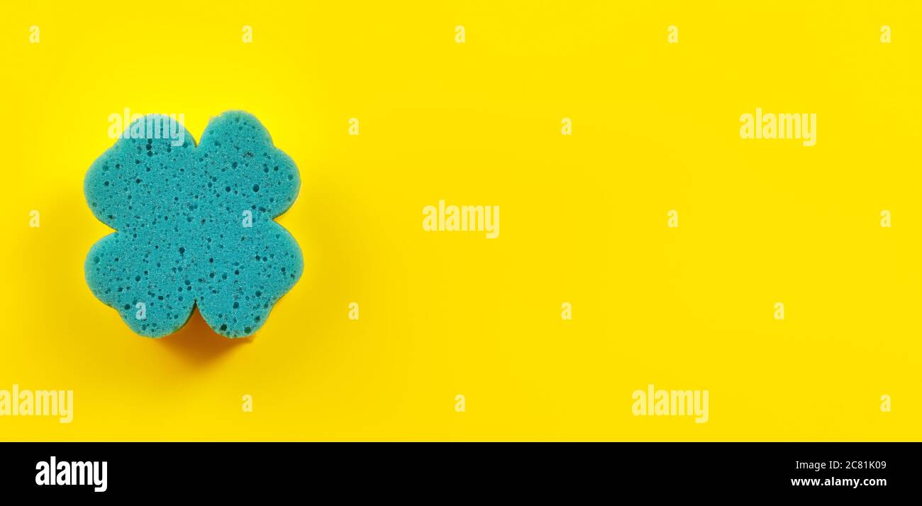 Top down view - blue bathroom sponge on yellow board, space for text ...